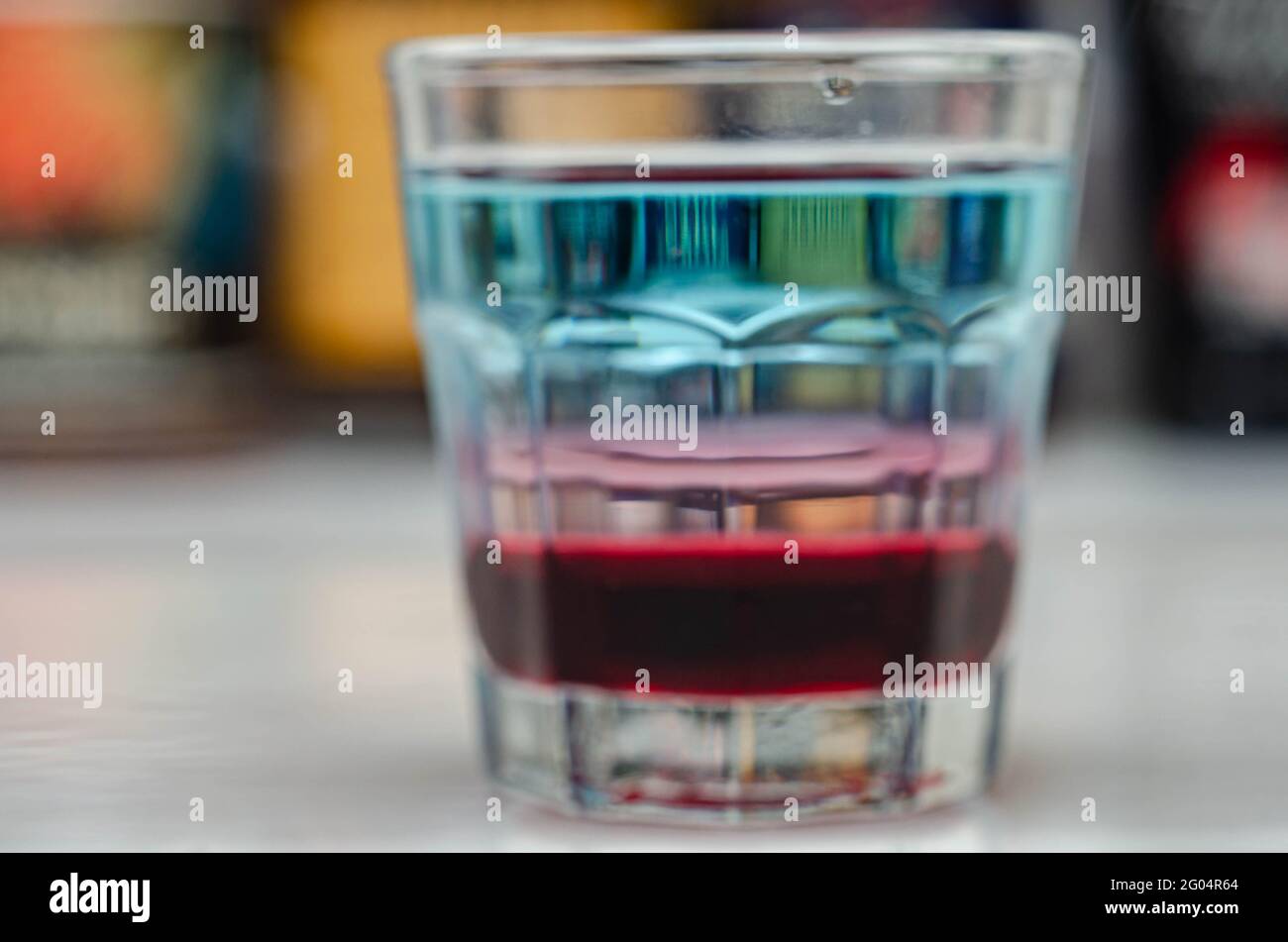 A colorful layered drink shot on a bar prepared by Bartender, party ...