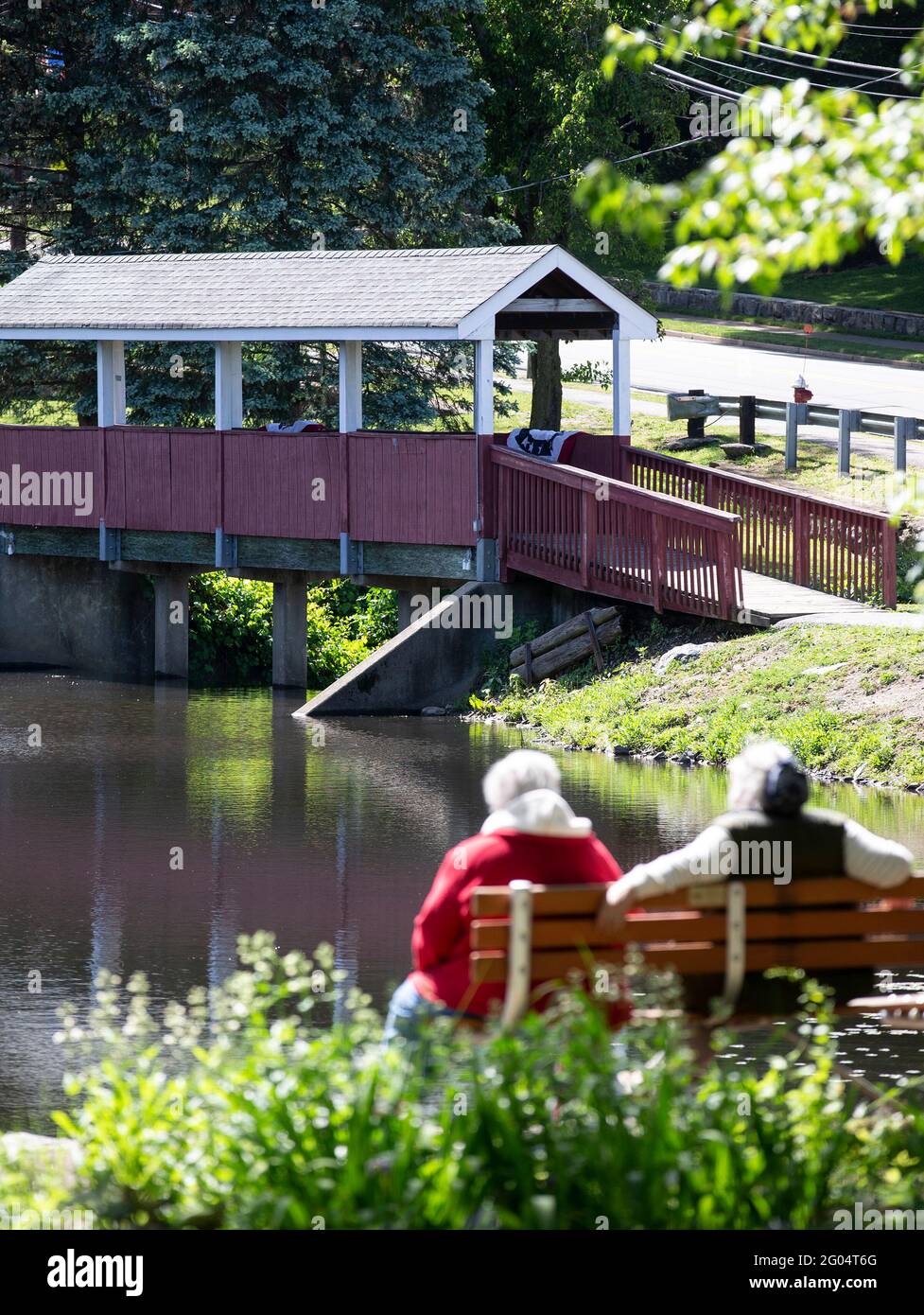 Two friends sitting on a park bench Stock Photo - Alamy