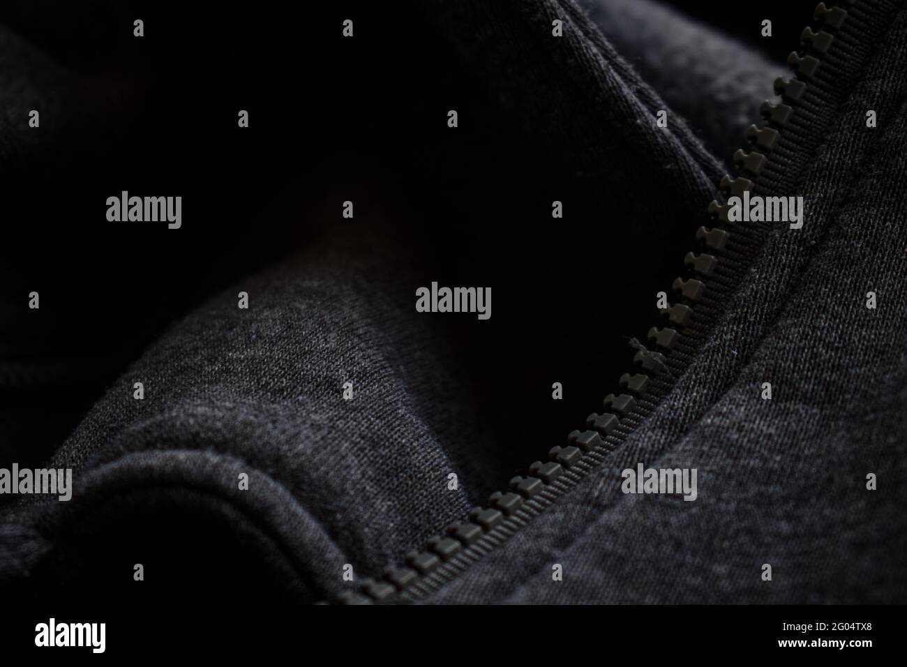 Close-up shot of a grey jacket and its zipper creating a detailed ...