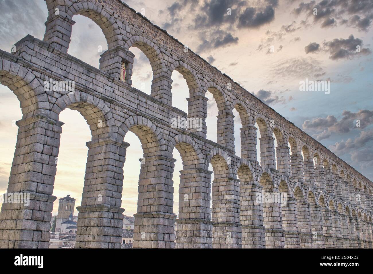 Landscape of The Aqueduct of Segovia under a cloudy sky in the evening ...