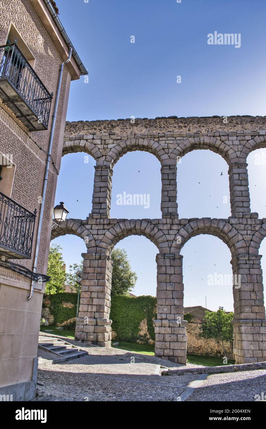 Vertical shot of The Aqueduct of Segovia under a blue sky and sunlight ...