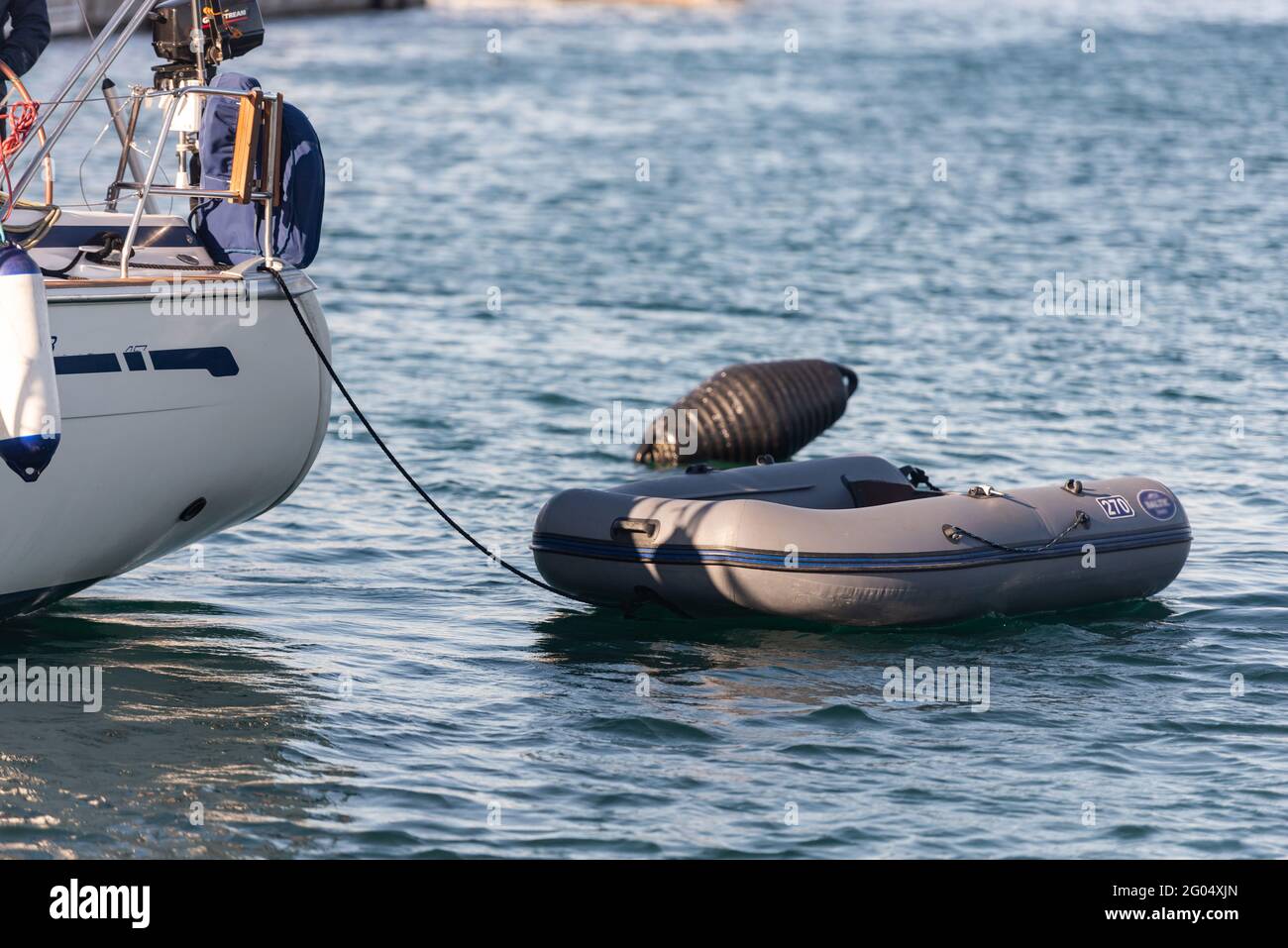 Inflatable boat from the stern of the yacht. Yacht in the parking lot ...
