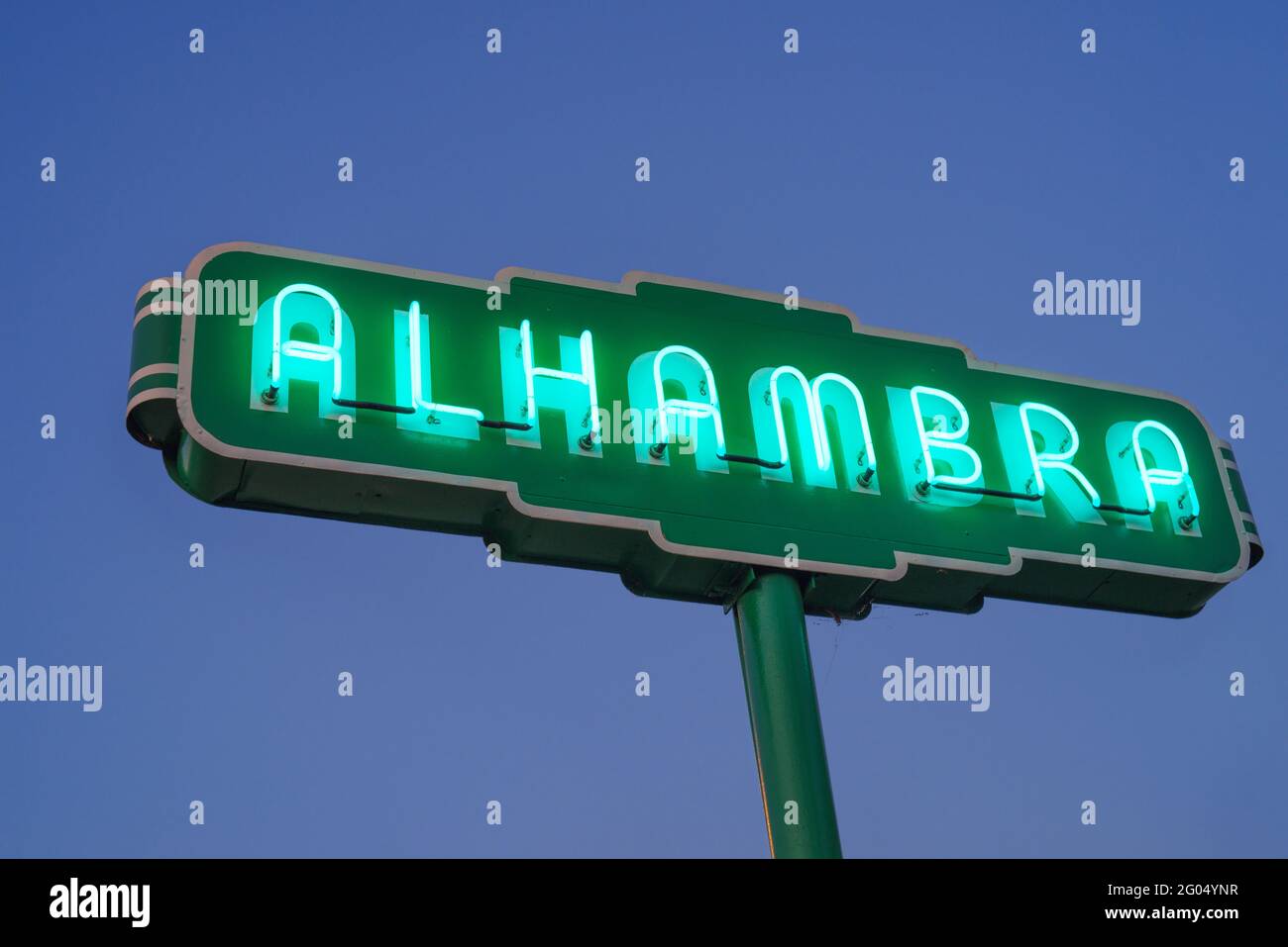 lit neon sign indicating the City of Alhambra, shown at dusk Stock ...