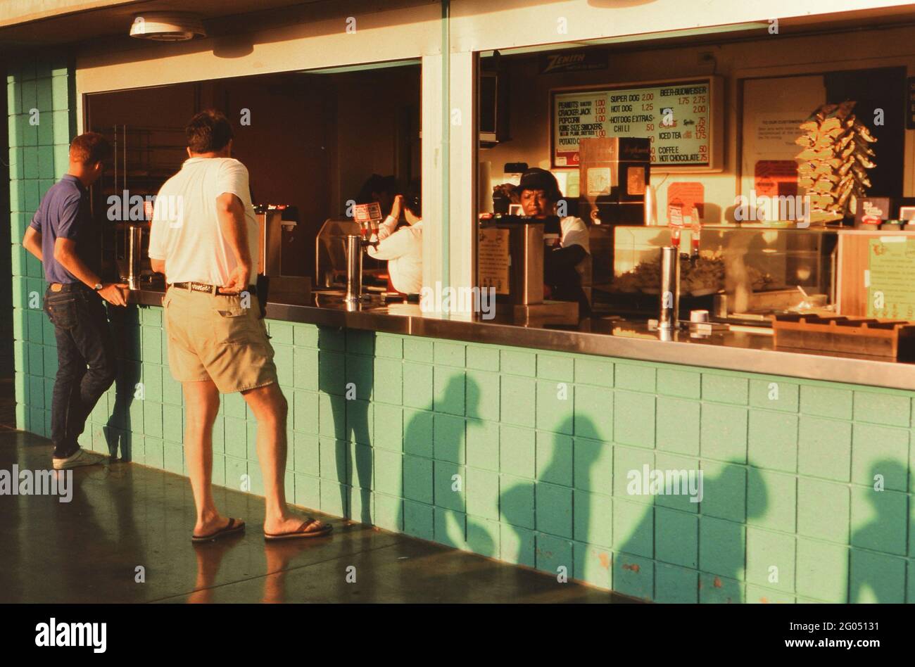 Baseball fans buying food and drinks at a concessions stand at a Major ...