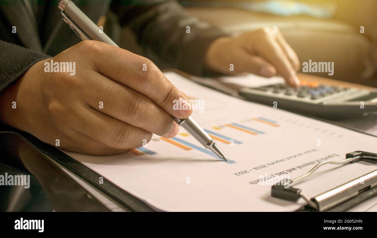 Business people reviewing reports, financial documents for analysis of ...