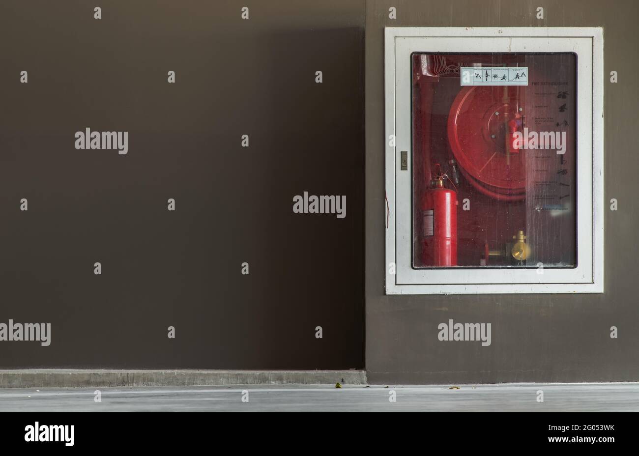 A white fire fighting equipment cabinet or fire extinguishing cabinet ...