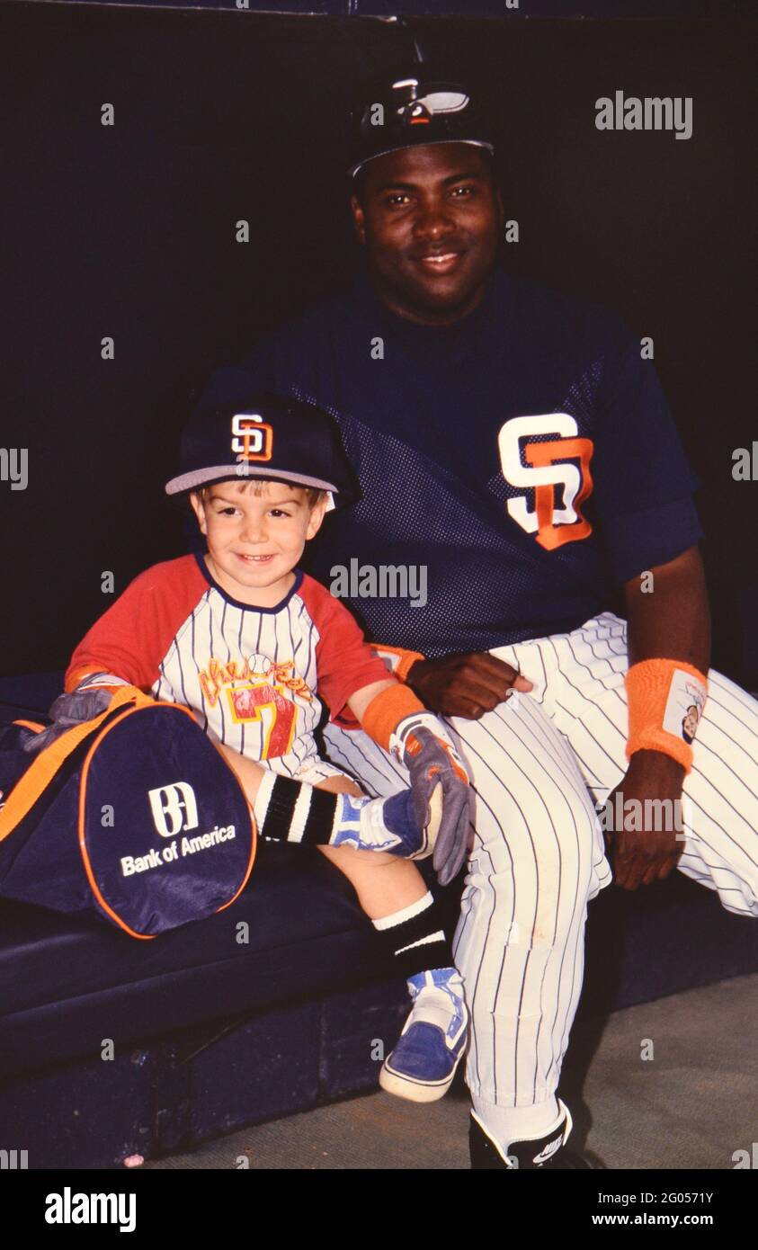 A young baseball fan and Tony Gynn sitting in a dugout -- Please credit ...