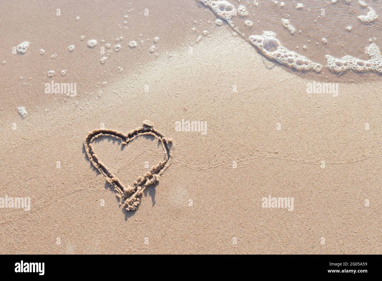 One Heart Drawn in the Sand on a Beach.soft wave of the sea.Real ...