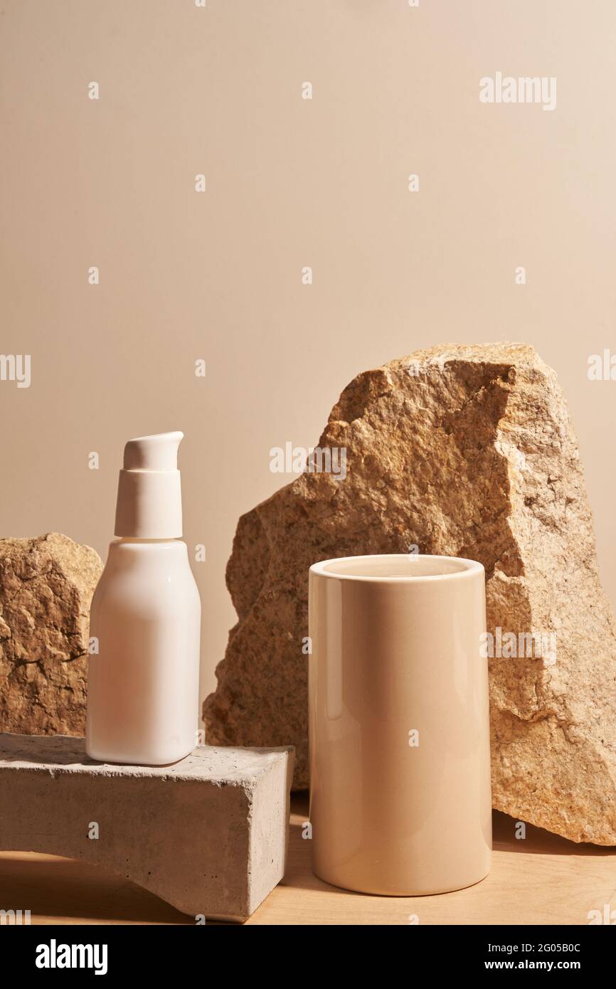 White ceramic opaque bottle on a beige background without labels on ...
