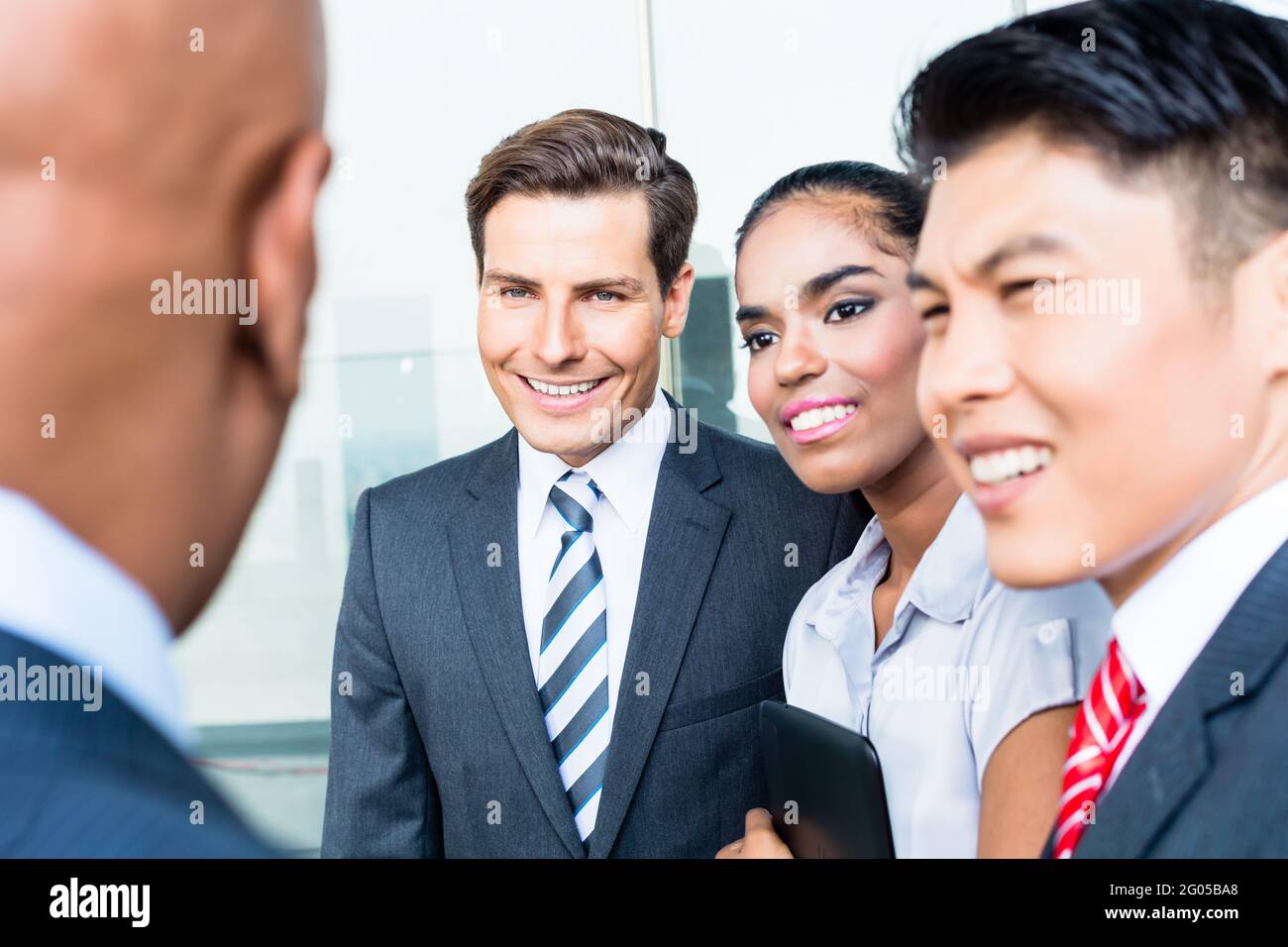 Asian business team discussing and sharing ideas with their Indian boss ...