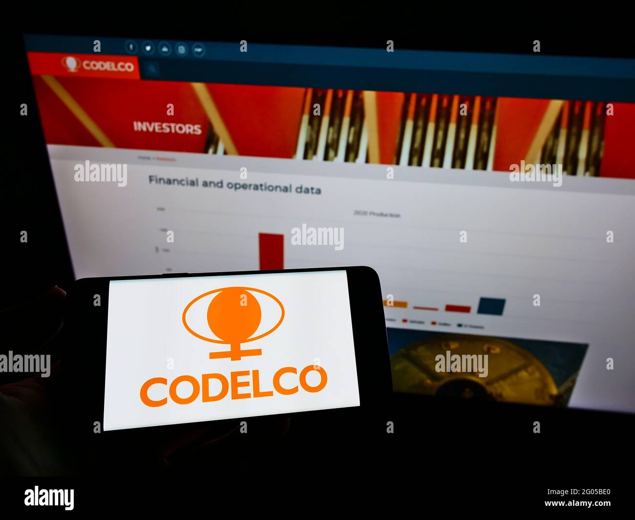 Person holding cellphone with logo of Chilean mining company Codelco on ...