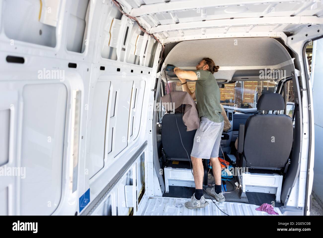 Man customizing the inside of a van Stock Photo - Alamy