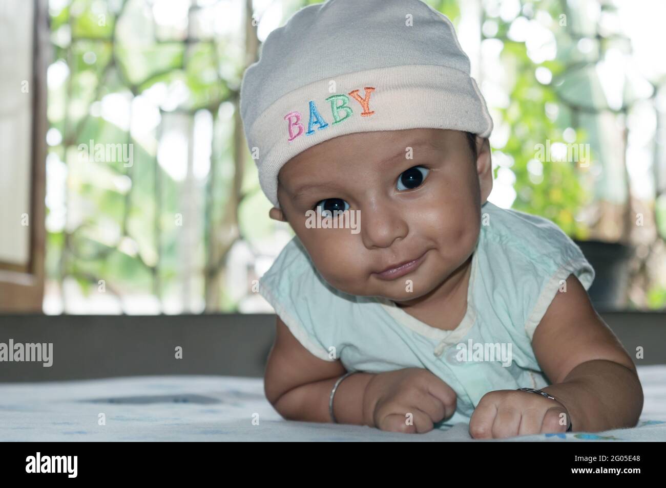 Cute baby lifting head. Closeup portrait. Happy baby boy looking and ...