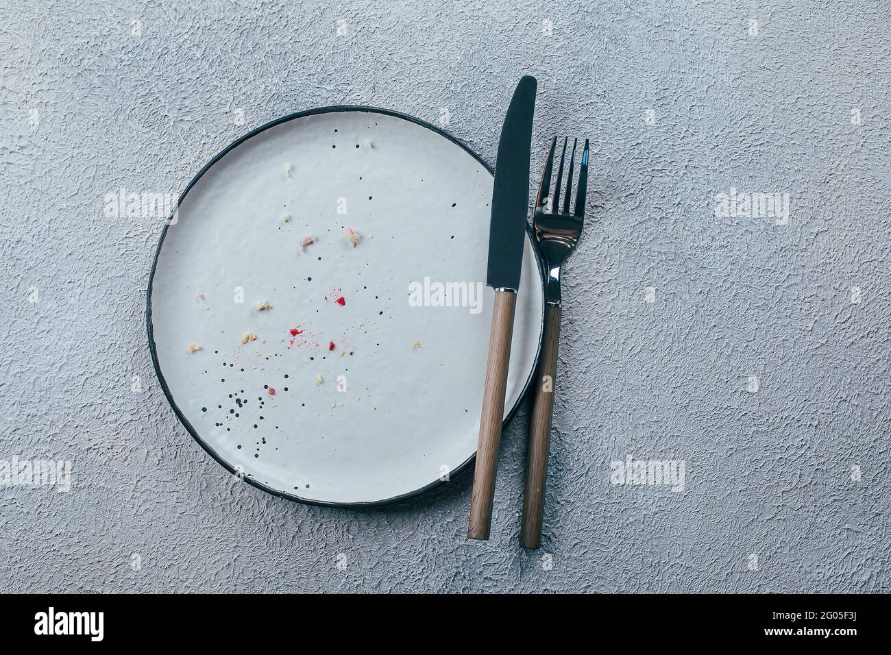 Empty plate with crumbs after eating. The concept of the end of ...