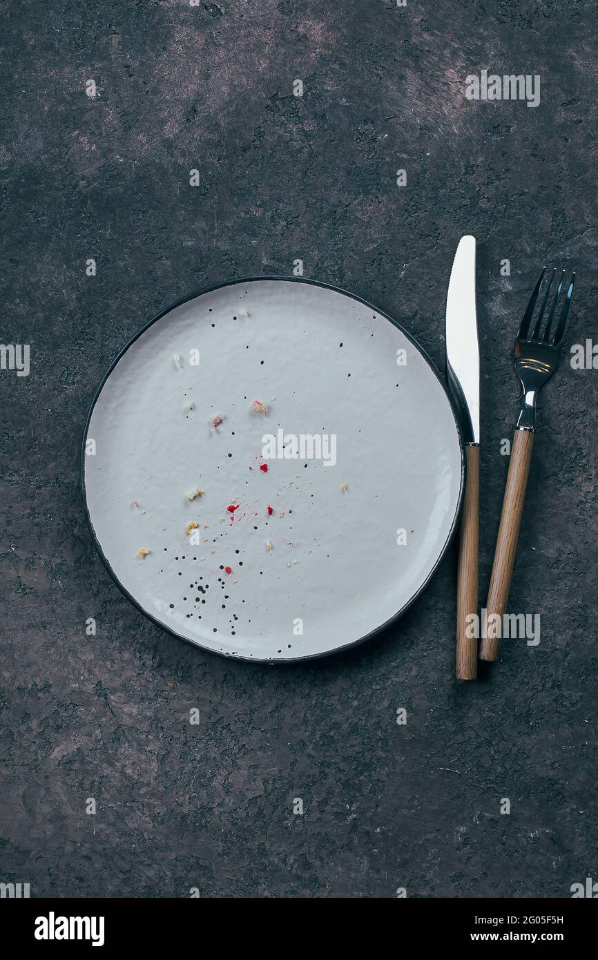 Empty plate with crumbs after eating. The concept of the end of ...