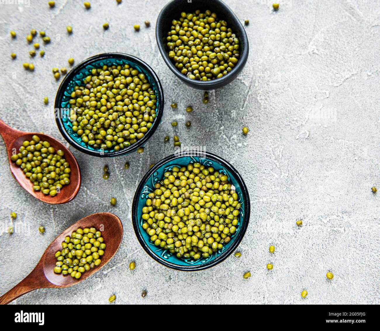 Raw mung beans in the bowls on a grey concrete background Stock Photo ...