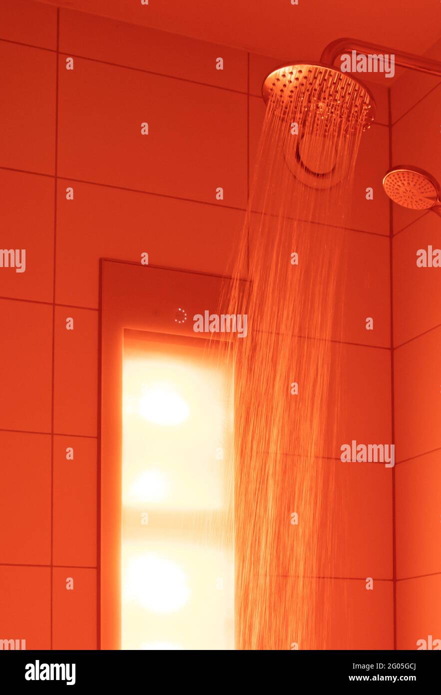 Luxury sunshower in a bathroom, lights glowing while water is flowing ...