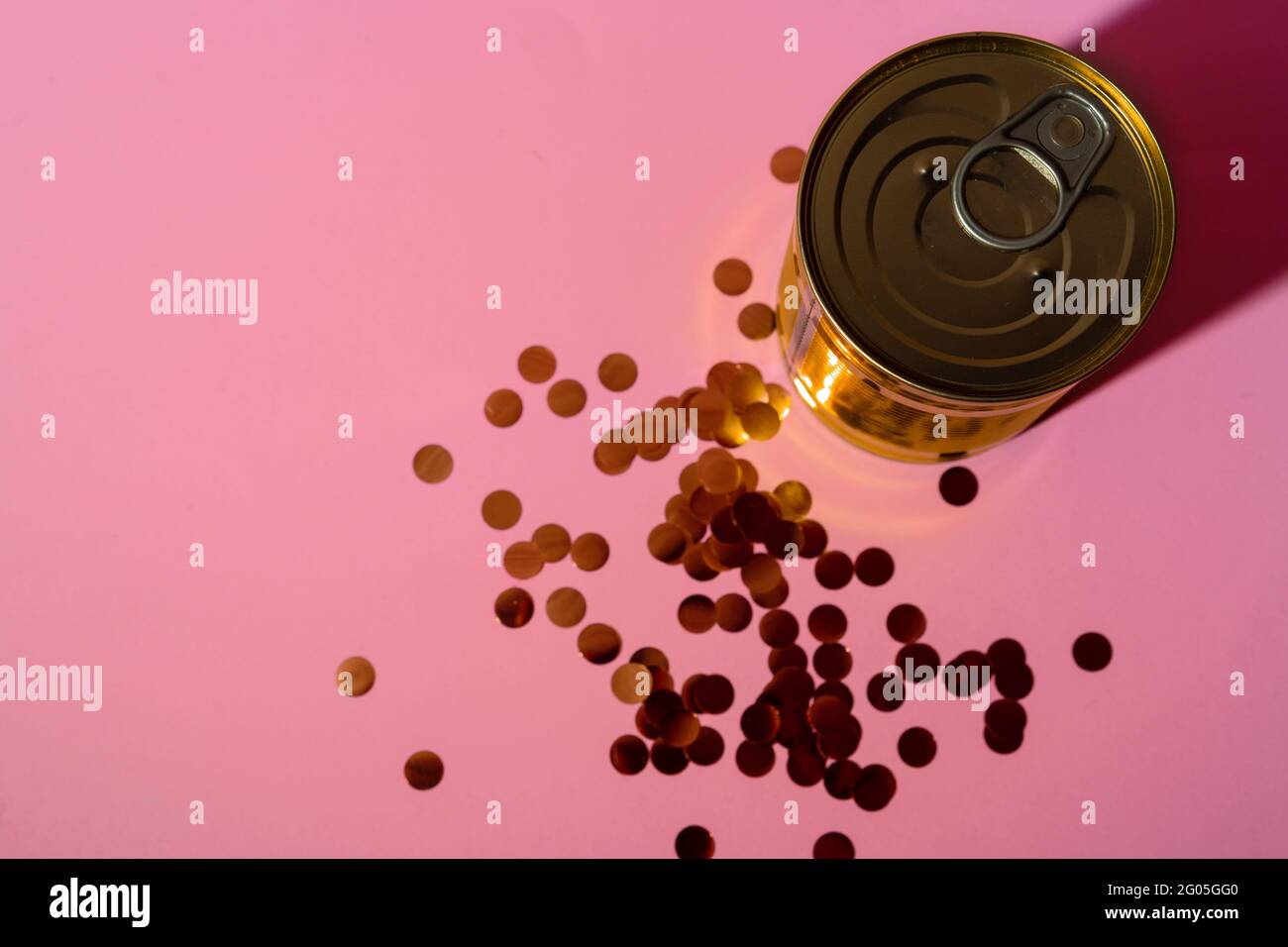 Canned food tin on pink studio background Stock Photo - Alamy