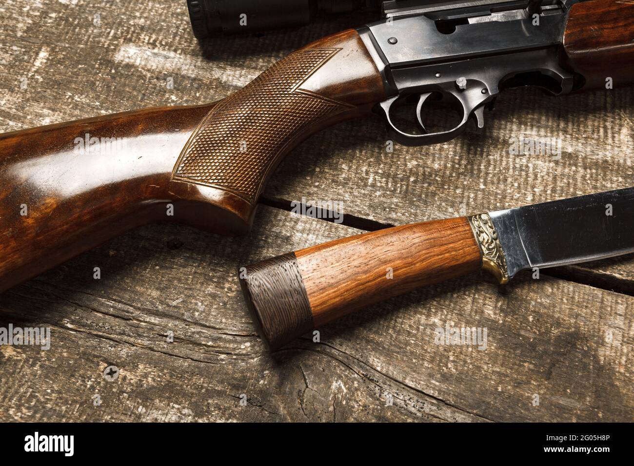 Wooden handle of hunting rifle on dark wooden background Stock Photo ...
