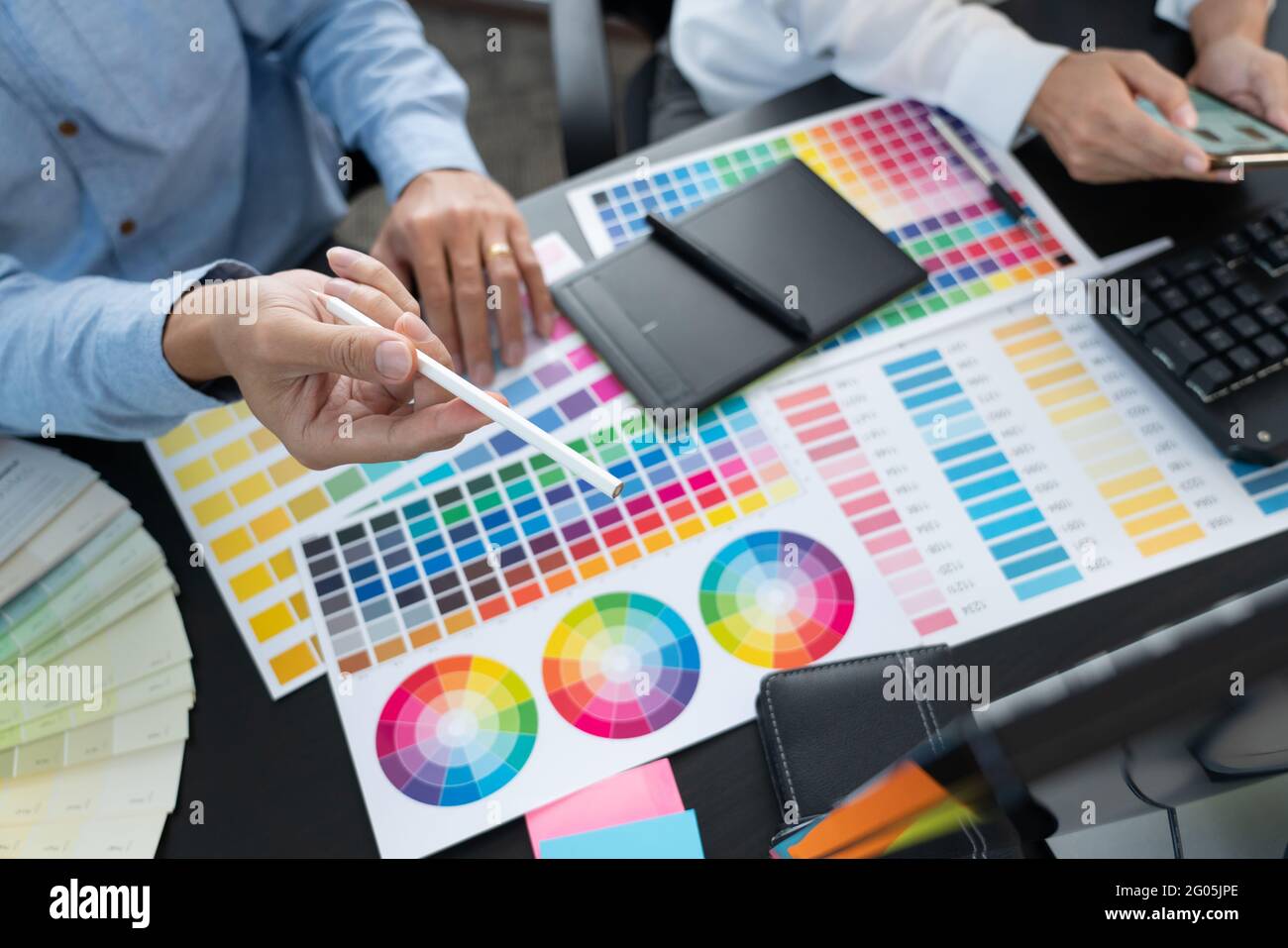 graphic designer team working on web design using color swatches ...