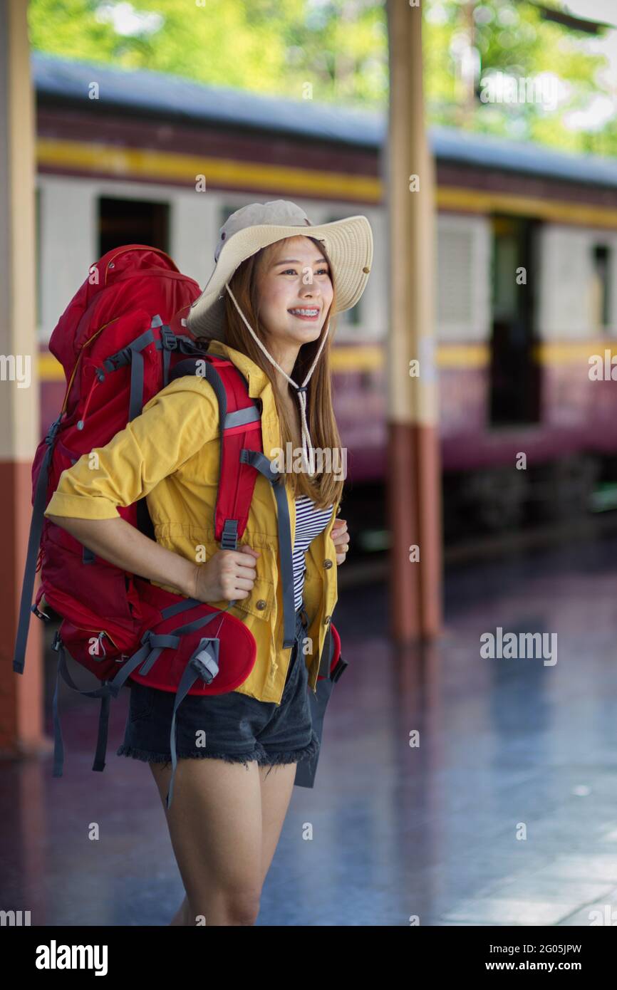 Portrait of young female backpacker smiling when arriving at her ...