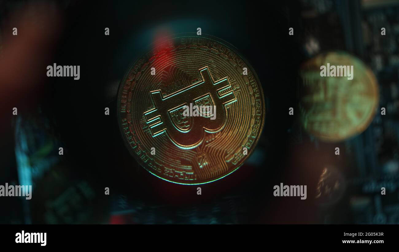 Physical Bitcoin (BTC) on the motherboard and processor (CPU) examining ...