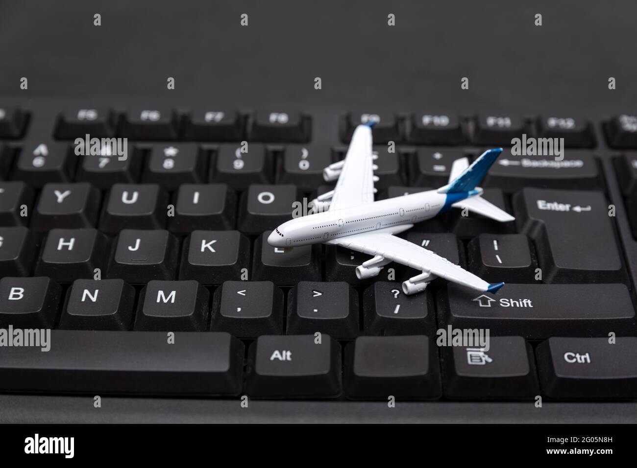 Airplane model on the keyboard. Online booking of air tickets. Buying ...