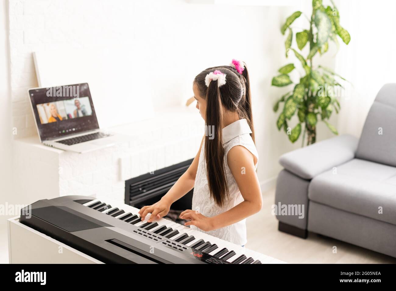 Homeschool little young kid girl learning piano from computer ...