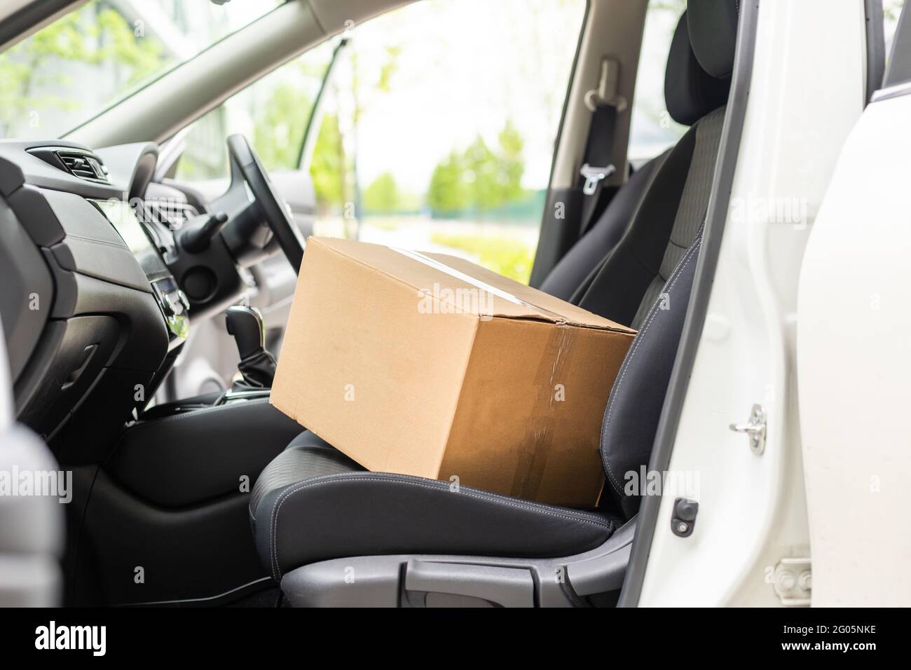 parcels in delivery car. driving with parcels Stock Photo - Alamy