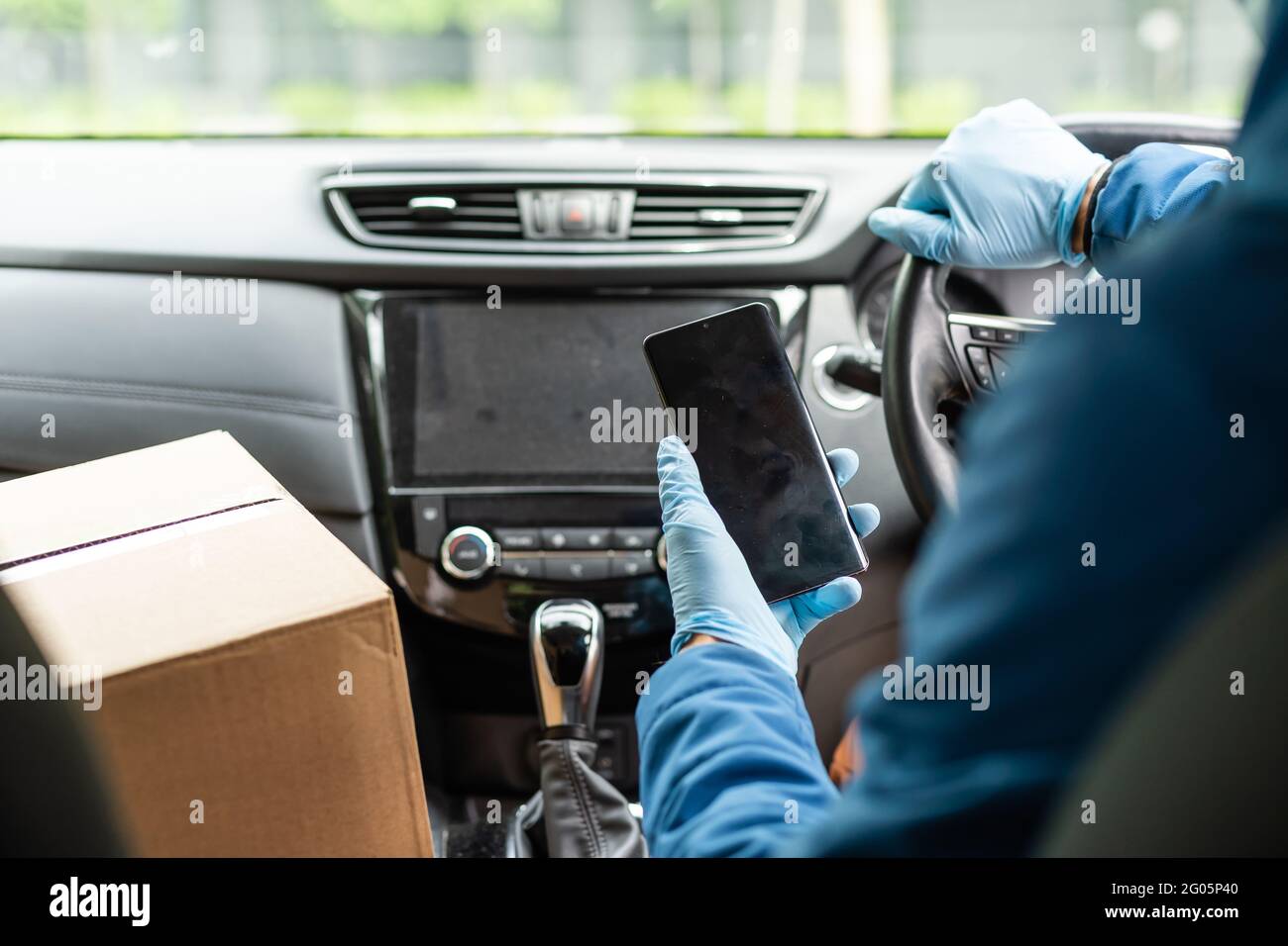 parcels in delivery car. driving with parcels Stock Photo - Alamy
