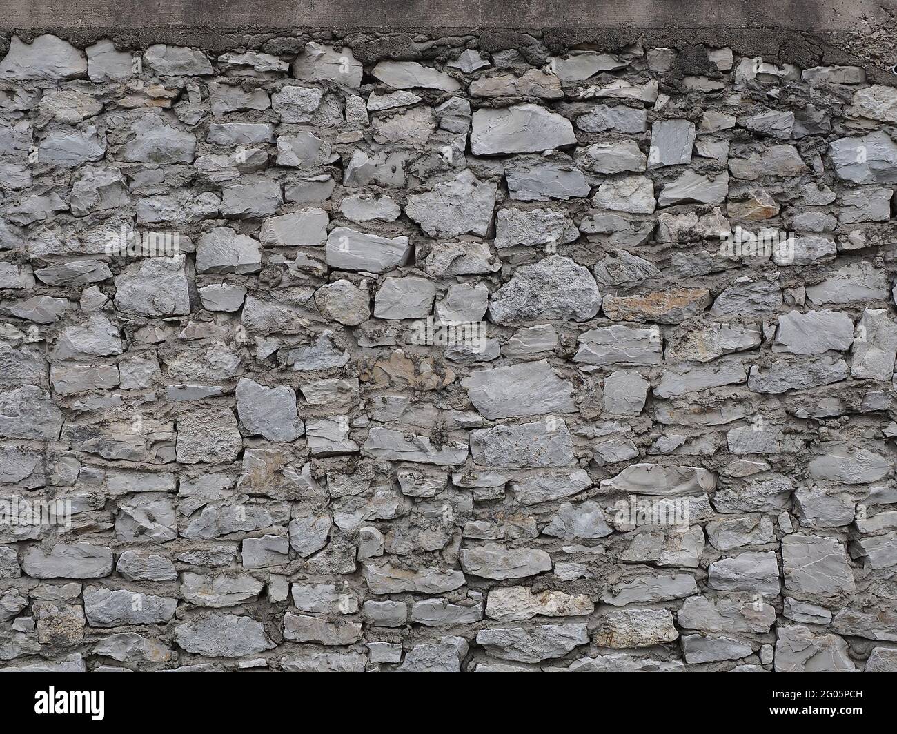 Unplastered wall of rough gray stone of various shapes and sizes Stock ...