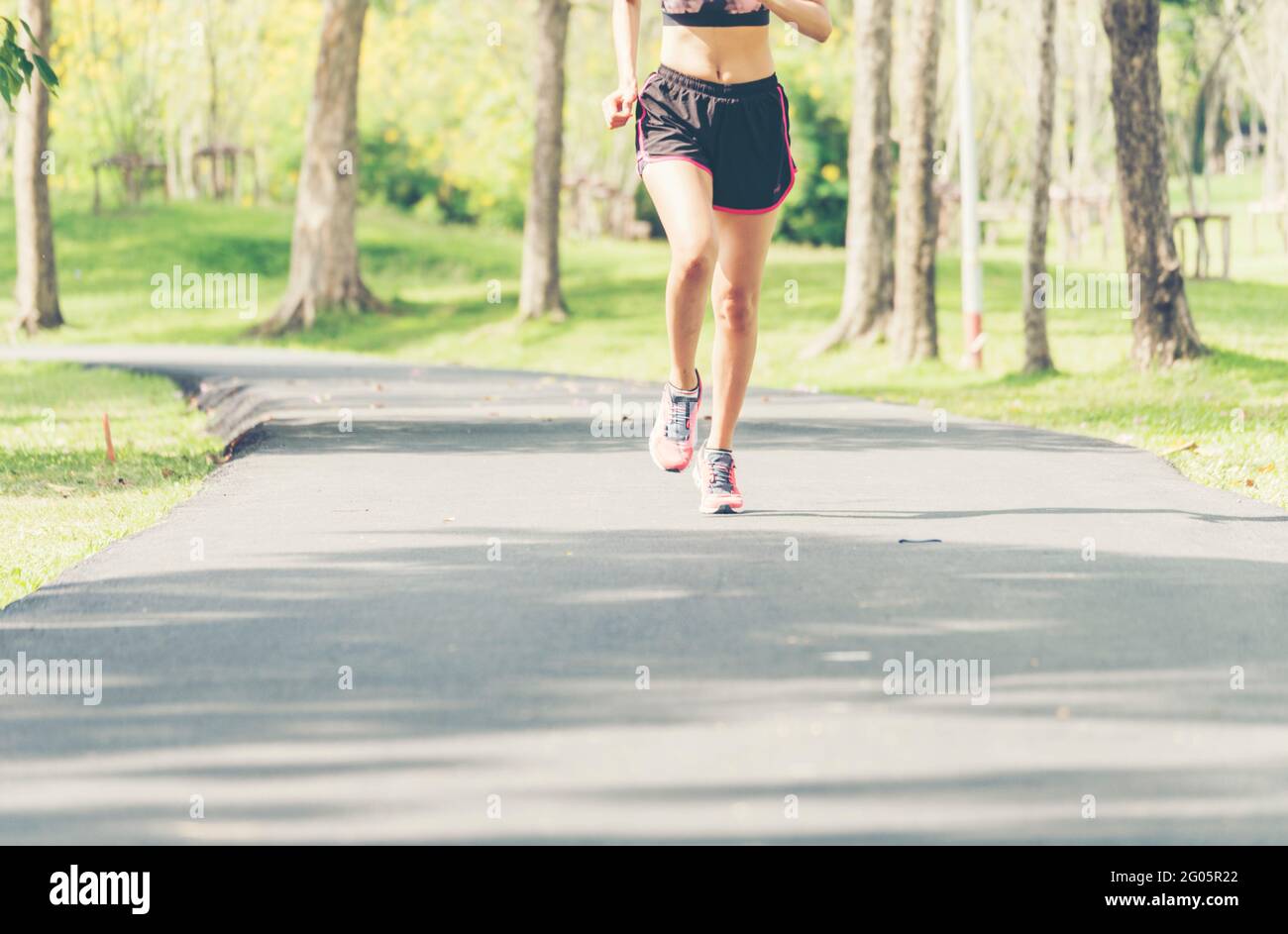 Marathon Runner Women running and work out at the park. Exercise in the ...