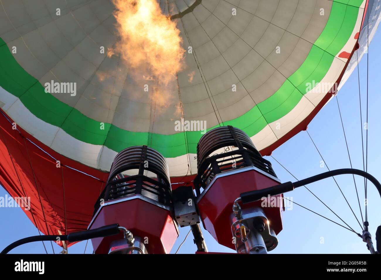 Low angle shot of the engines of a hot-air balloon shooting fire up ...
