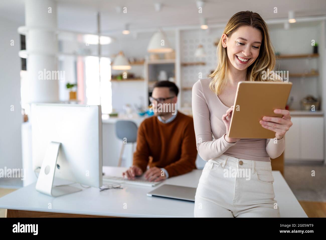 Positive couple having fun while working together remotely at home ...