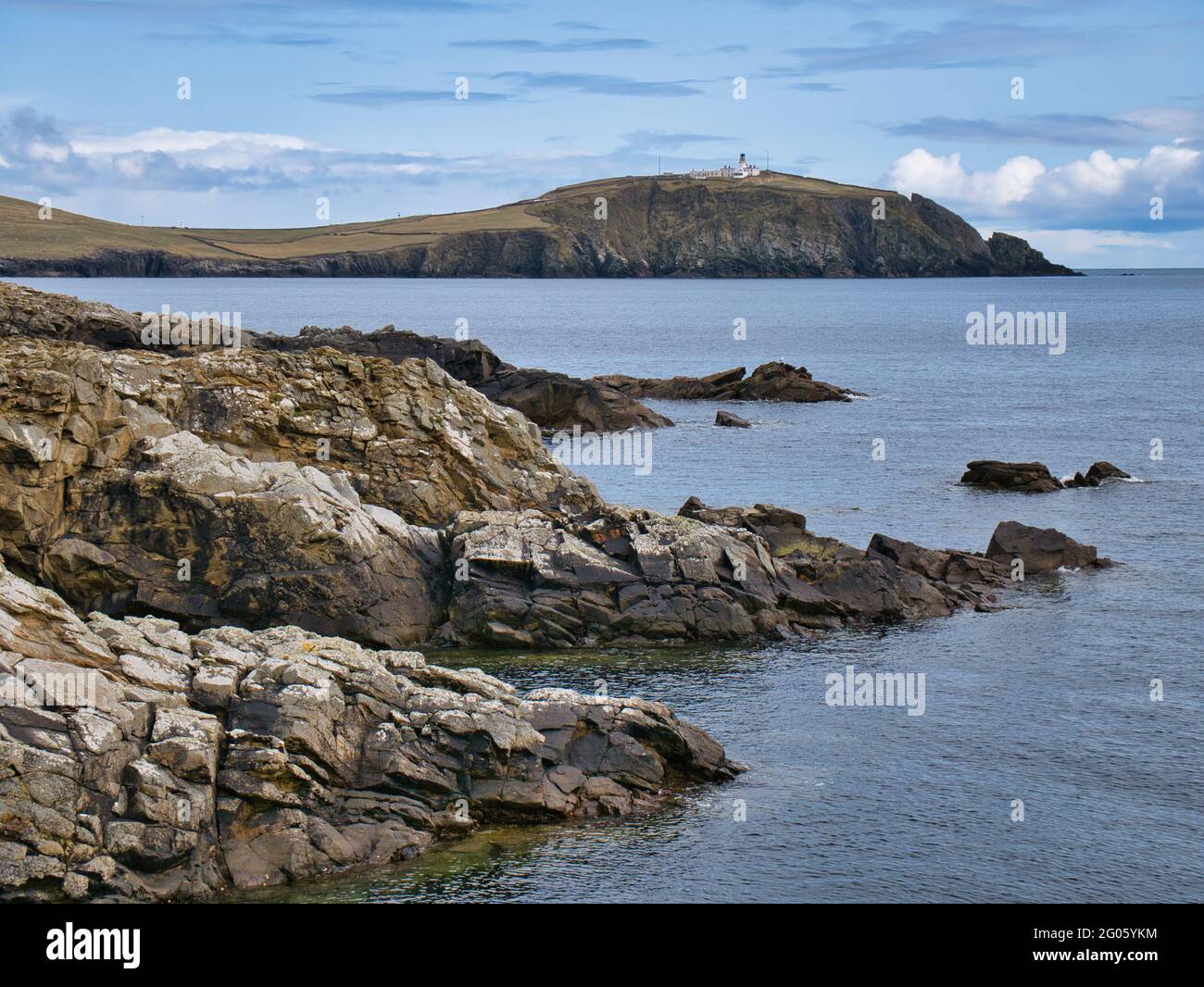 With Sumburgh Head and lighthouse behind, the steeply inclined ...
