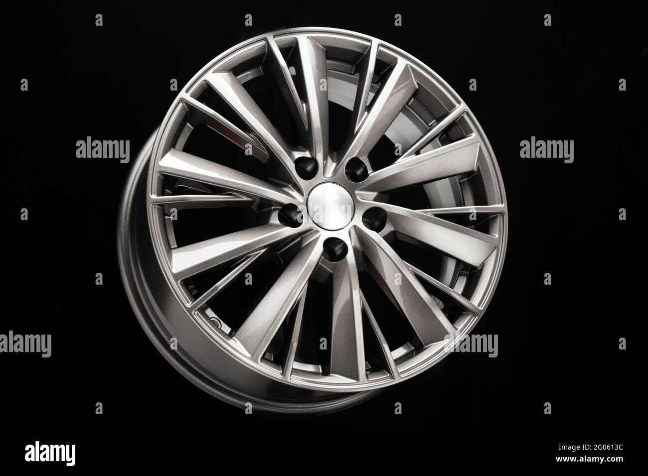 new beautiful silver alloy wheel on a black background. close-up Stock ...