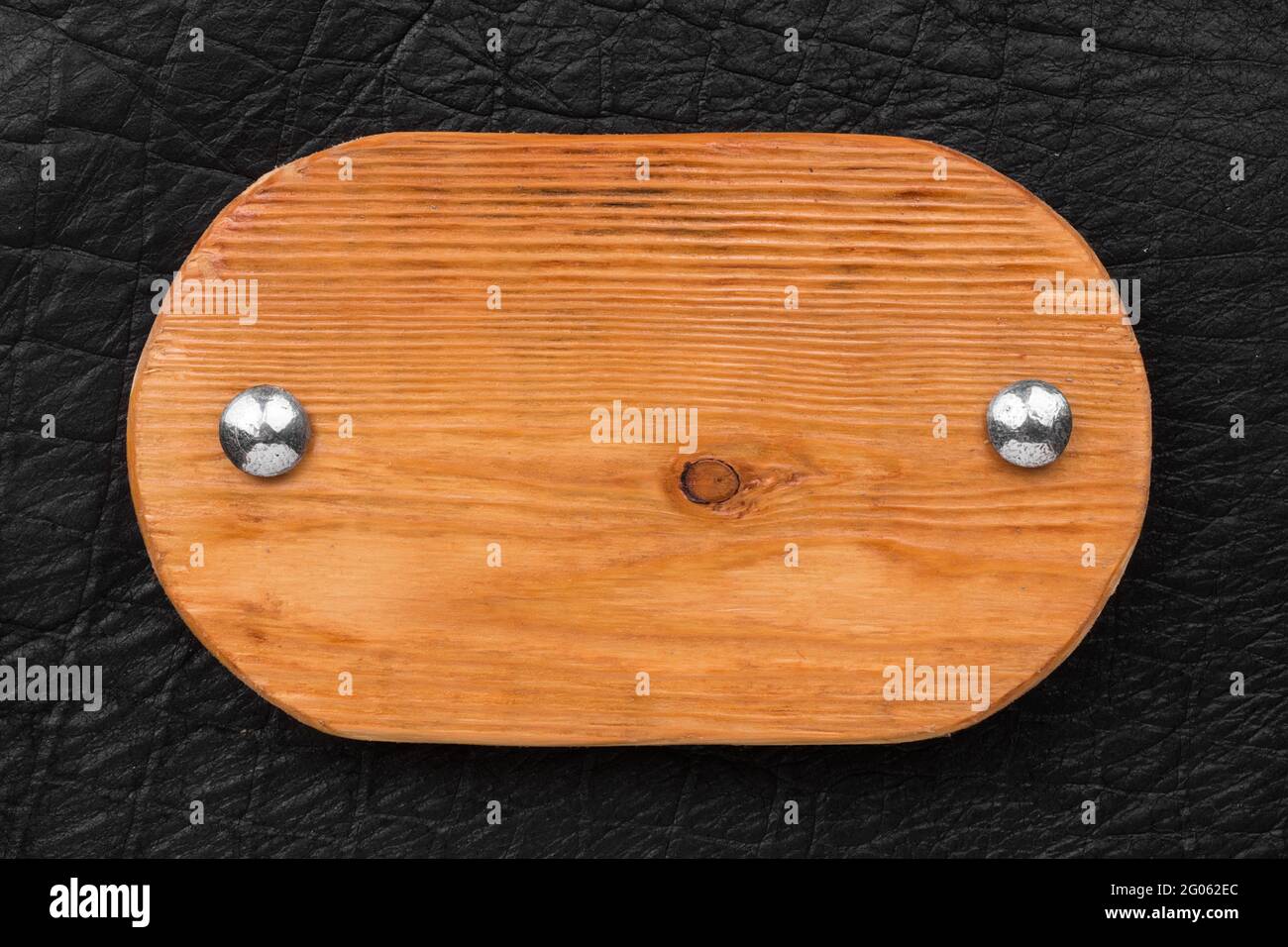 Sign made from a board, fastened with iron rivets on black leather. Top ...