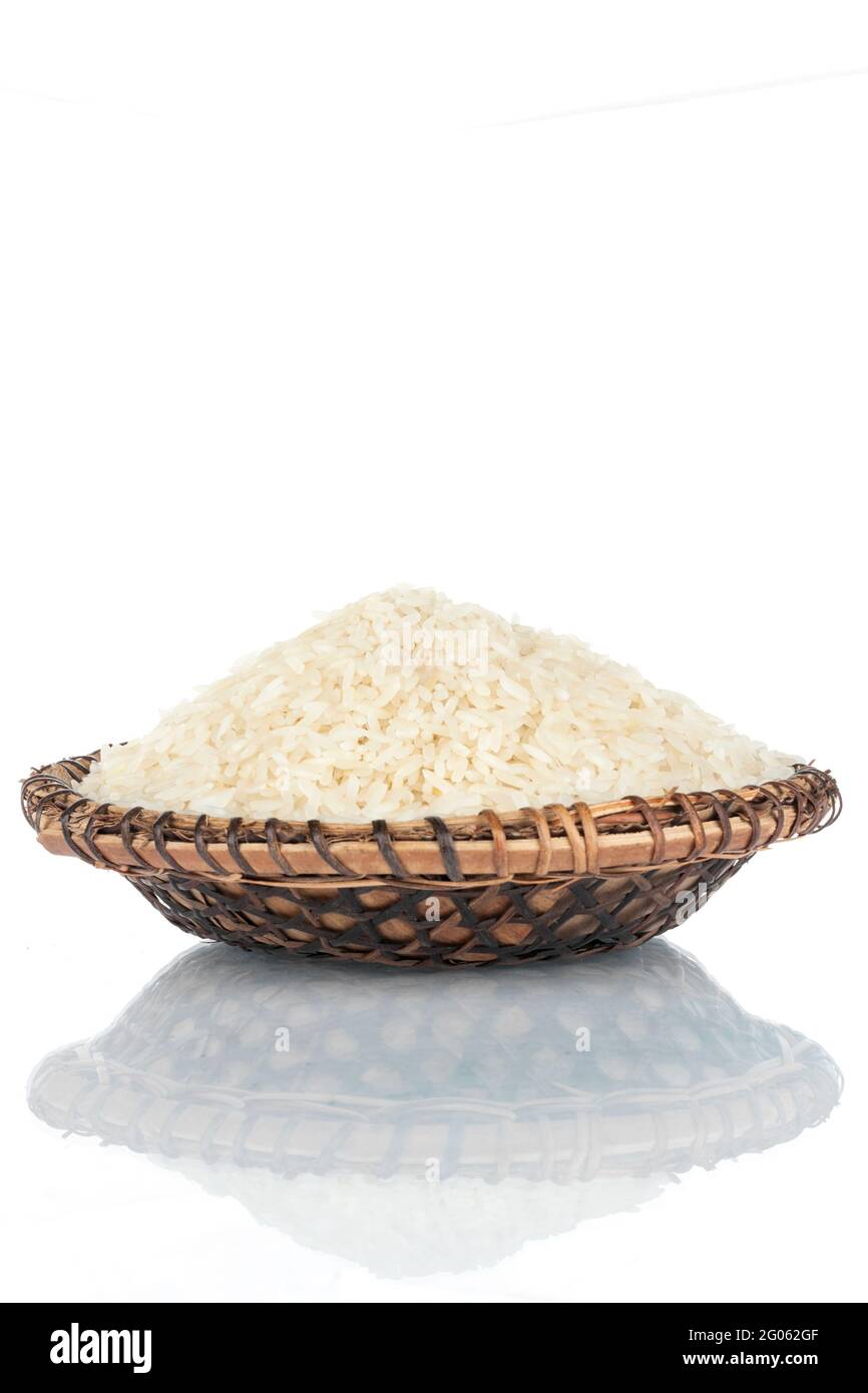 Heap of rice grains in a wooden plate. Isolated on white background ...