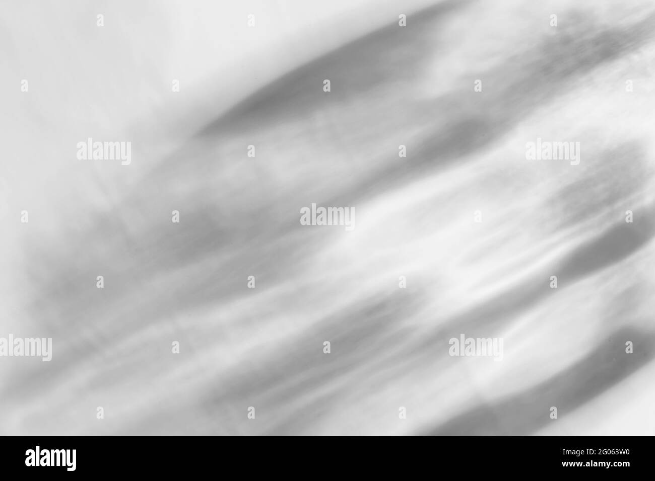 Glass drops diagonal shadow and light caustic effect on a white wall ...