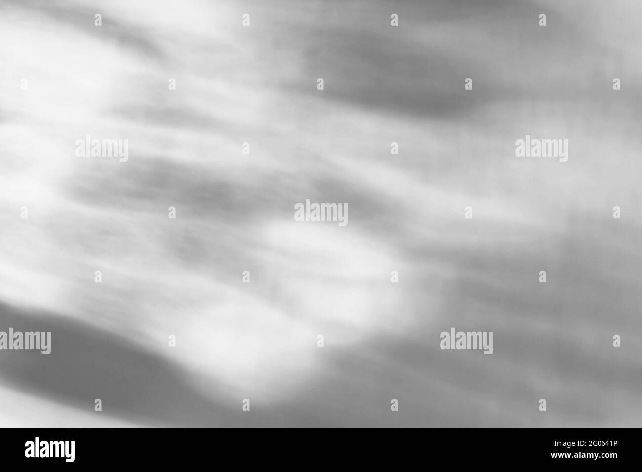 Glass drops diagonal shadow and light caustic effect on a white wall ...