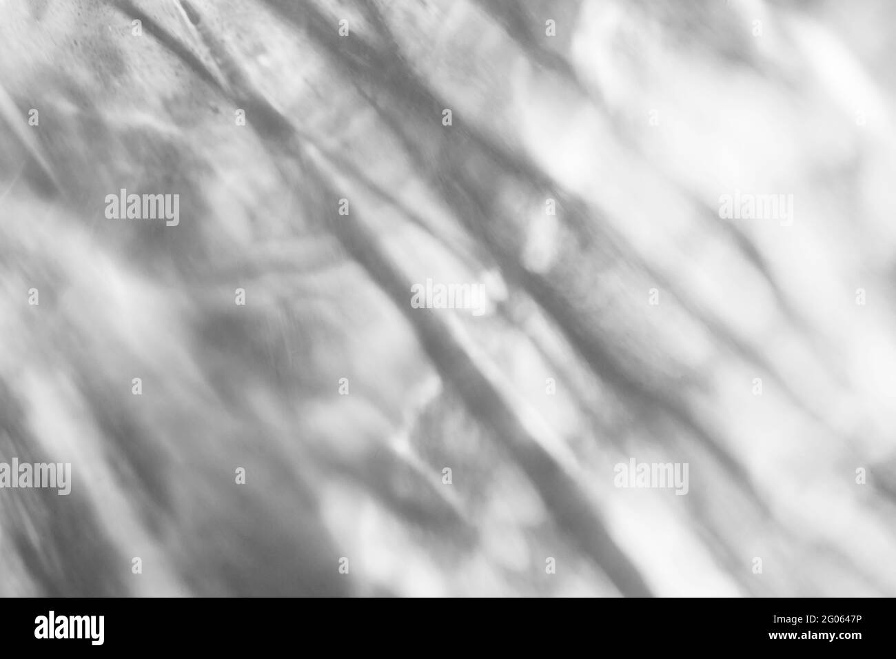 Glass drops diagonal shadow and light caustic effect on a white wall ...
