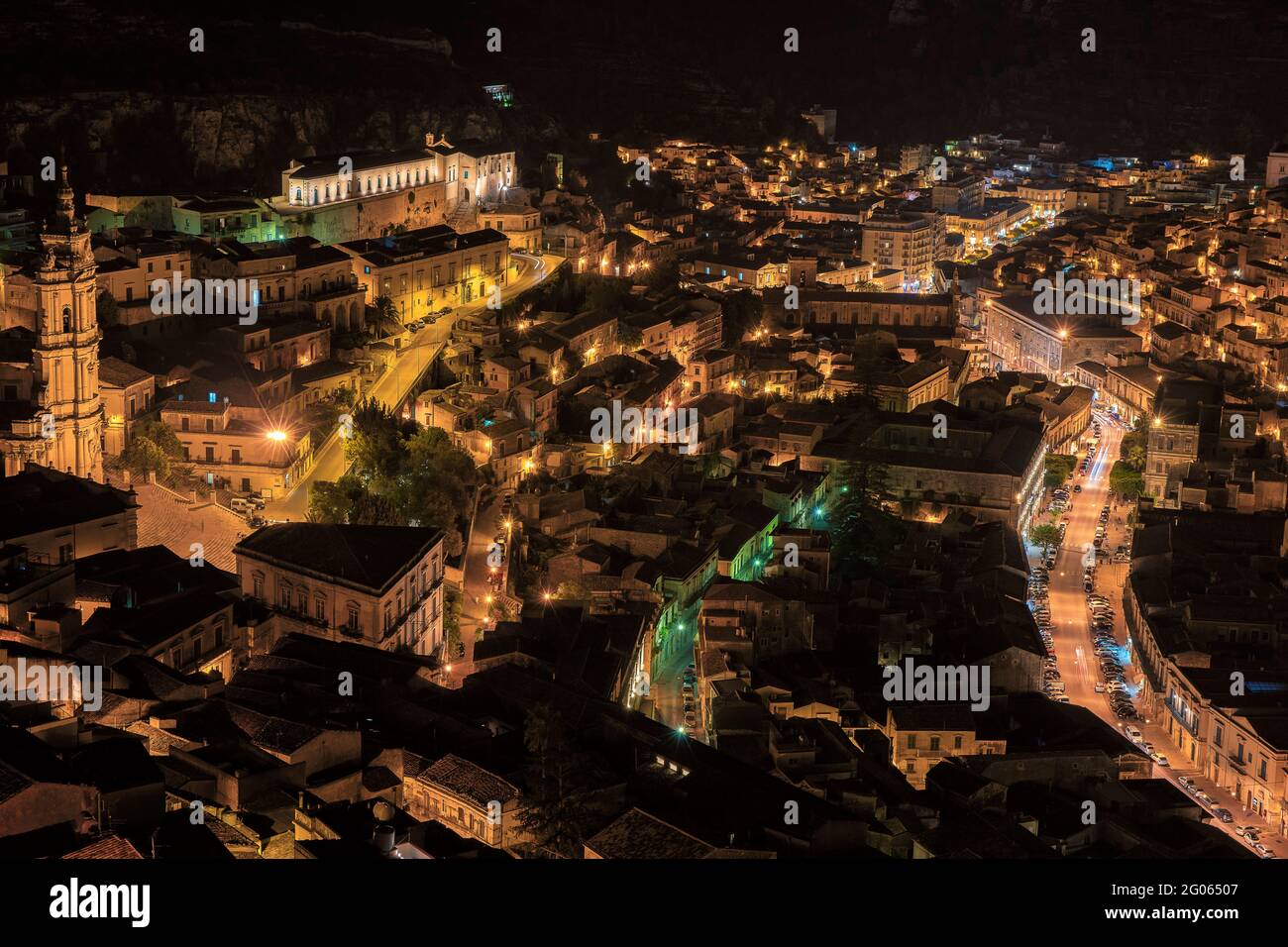 Aerial night view of Modica, the City of Chocolate which rises in Val ...
