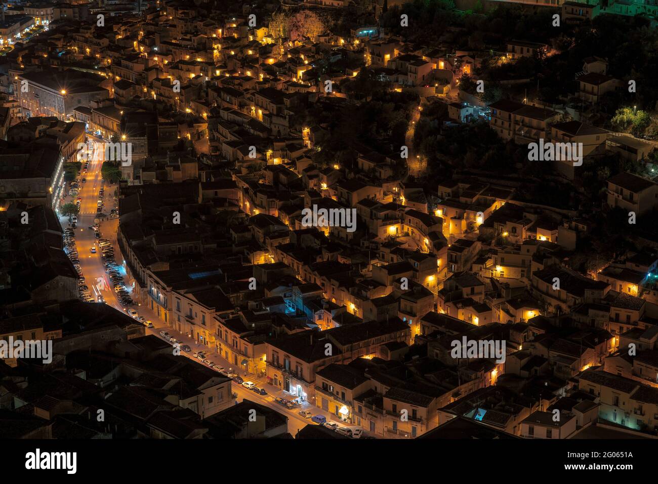 Aerial night view of Modica, the City of Chocolate which rises in Val ...
