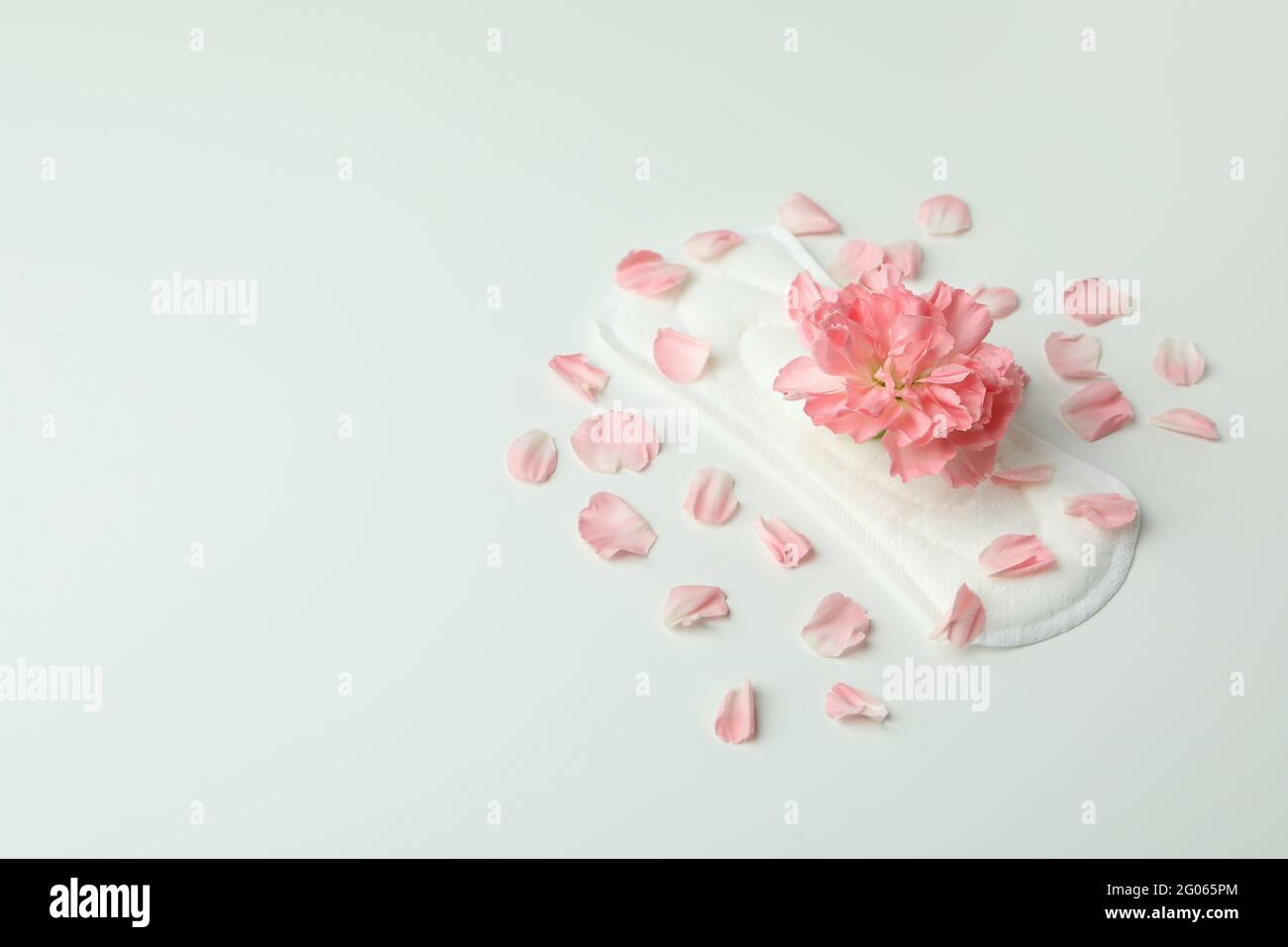 Hygiene pad with flower and petals on white background Stock Photo - Alamy