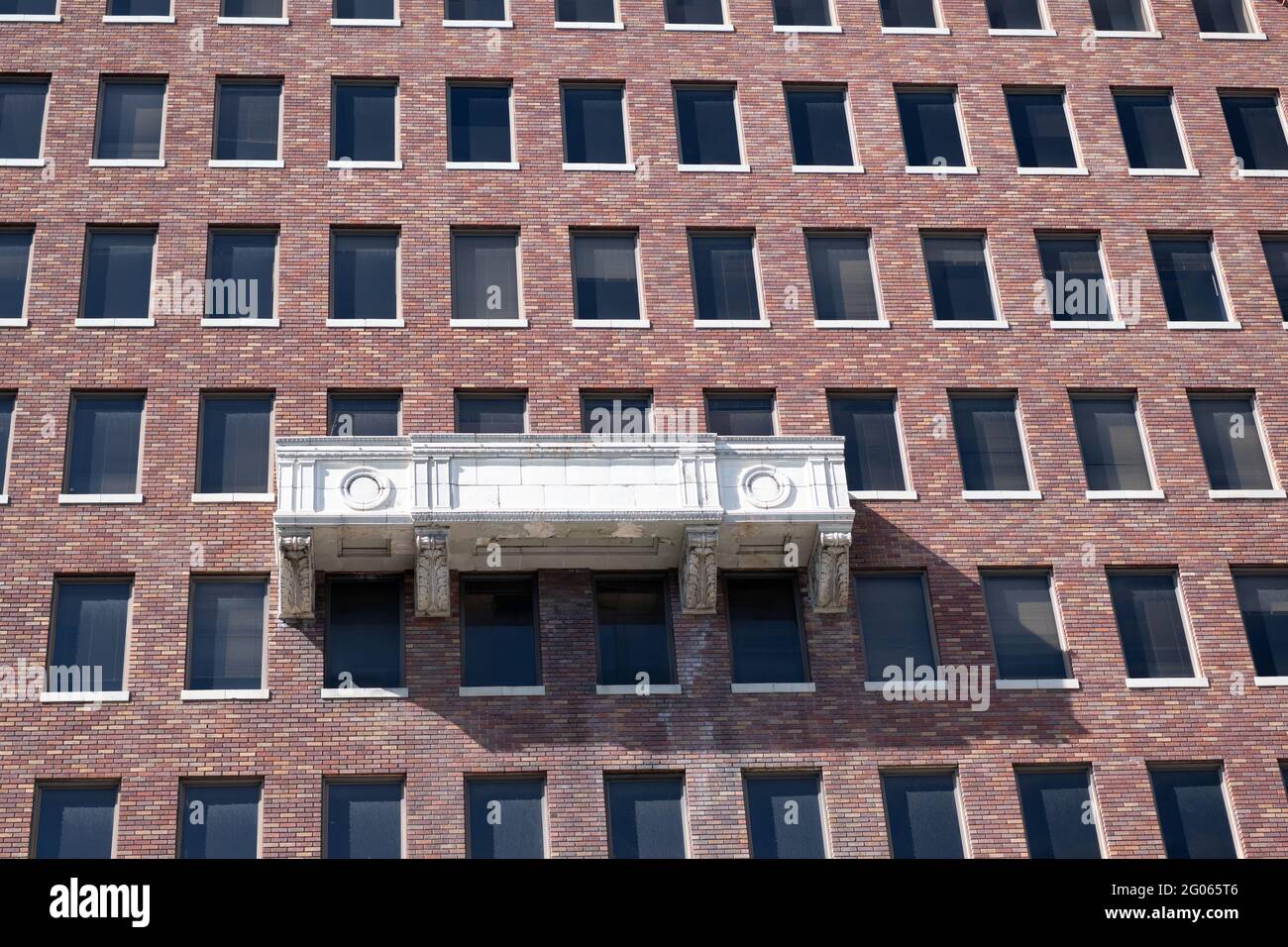 Less is better more. White balcony on brick house. Brick-built ...