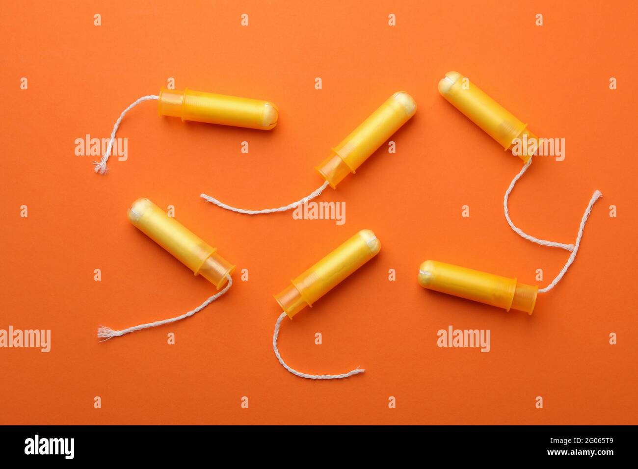 Women tampons on orange background, top view Stock Photo - Alamy