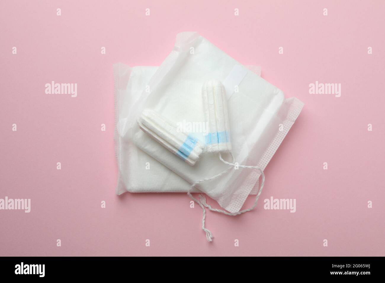 Sanitary pads and tampons on pink background Stock Photo - Alamy