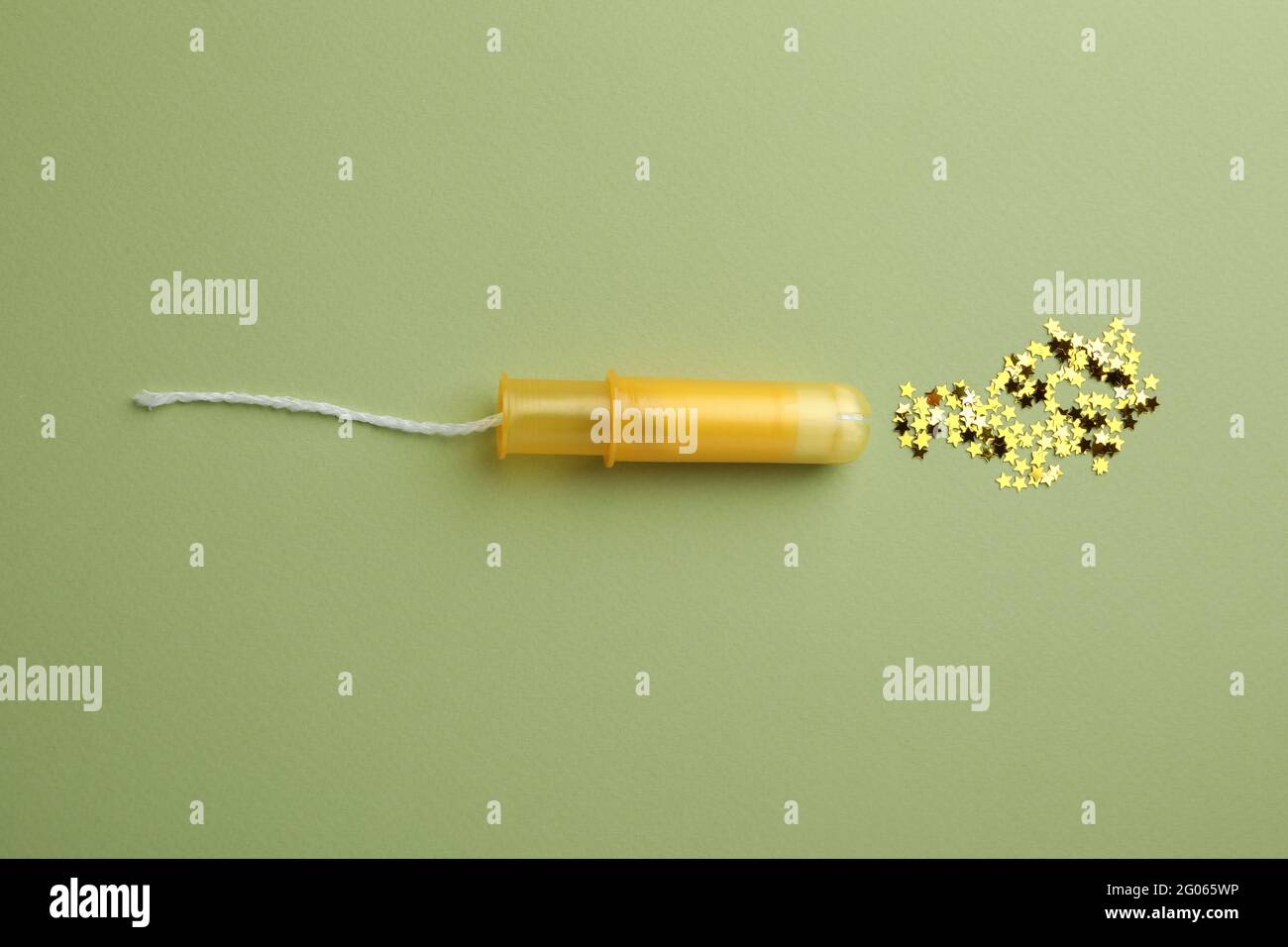 Fresh tampon and glitter on green background Stock Photo - Alamy