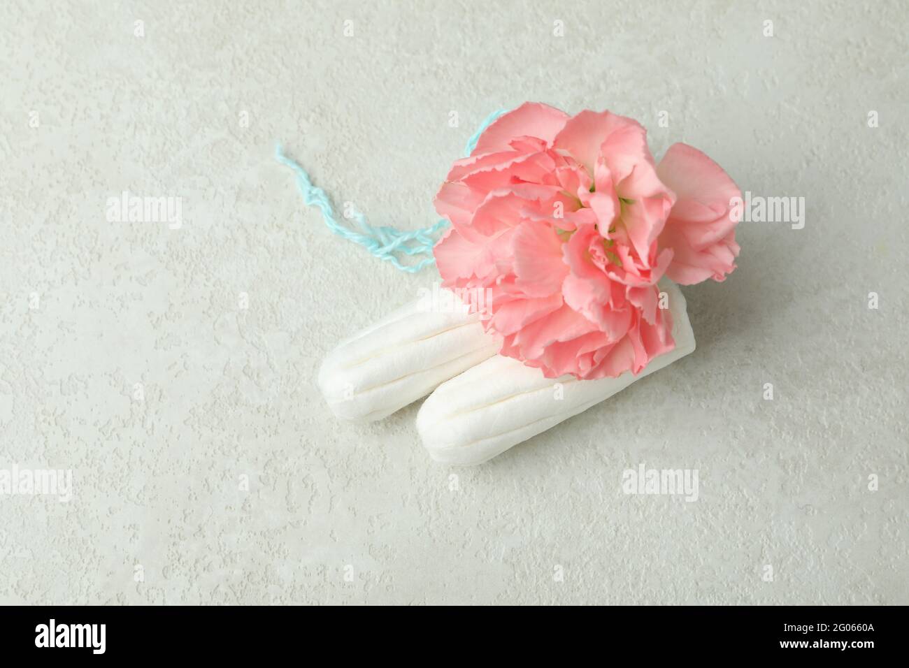 Tampons and flower on white textured background Stock Photo - Alamy