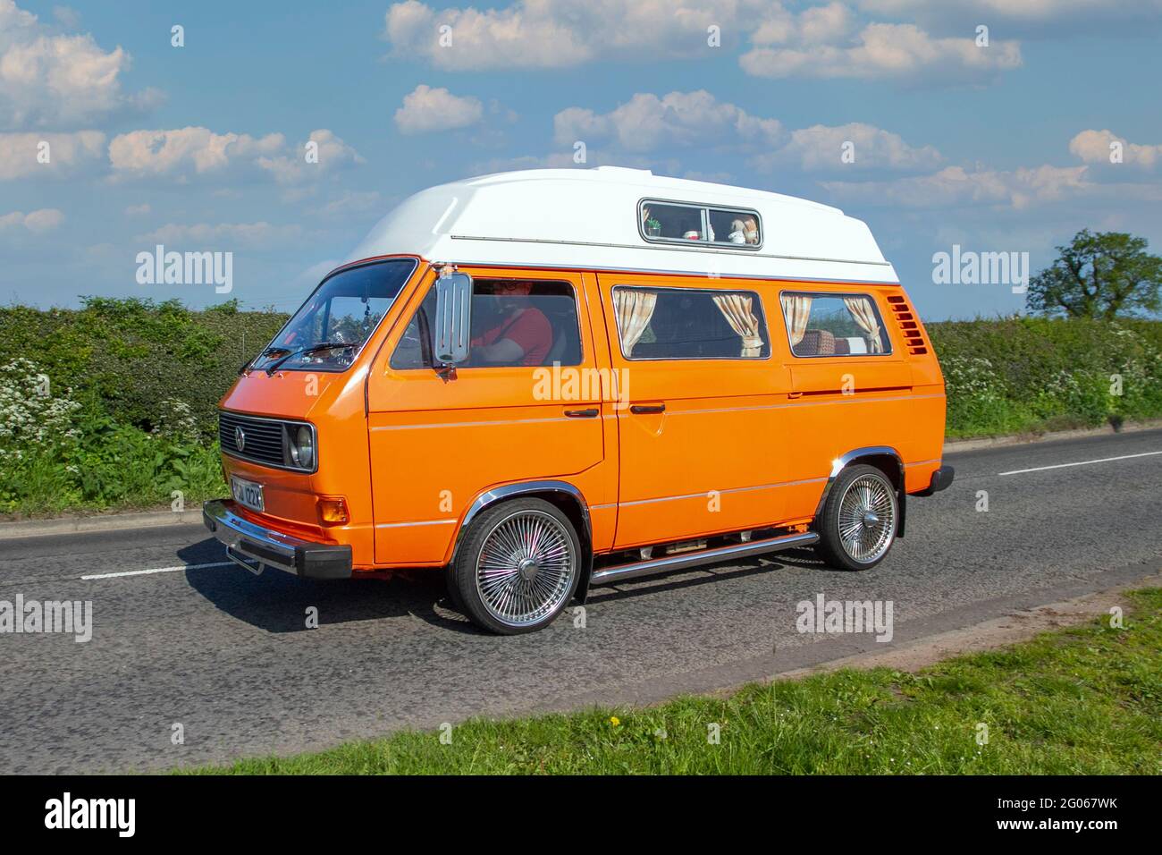1981 80s orange Vw Volkswagen driving on country roads en-route to ...
